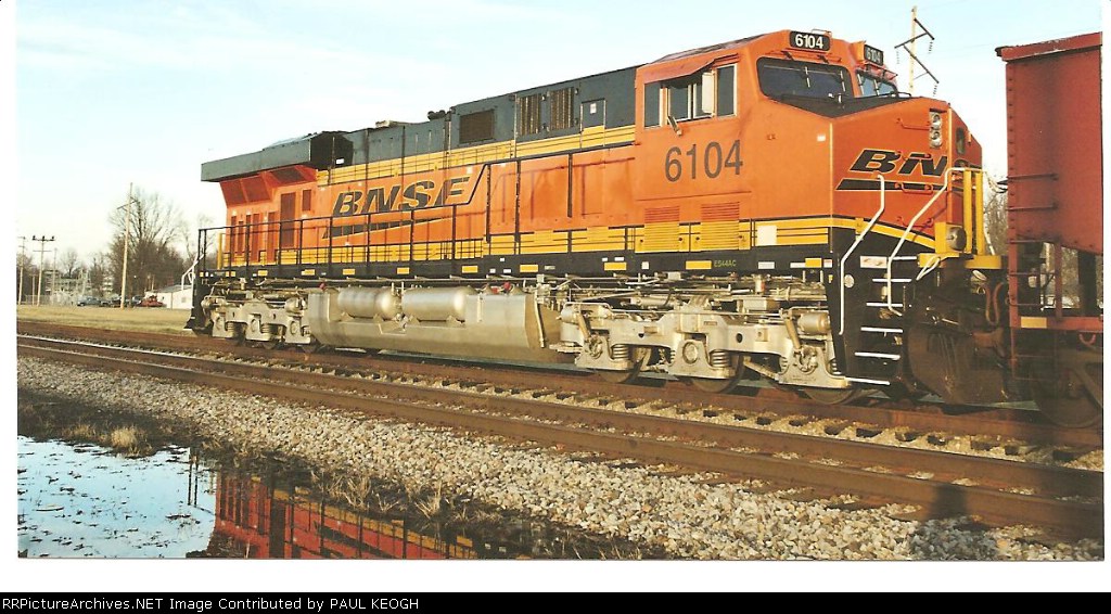 In the siding. BNSF 6104 glows with setting sun and the flash.